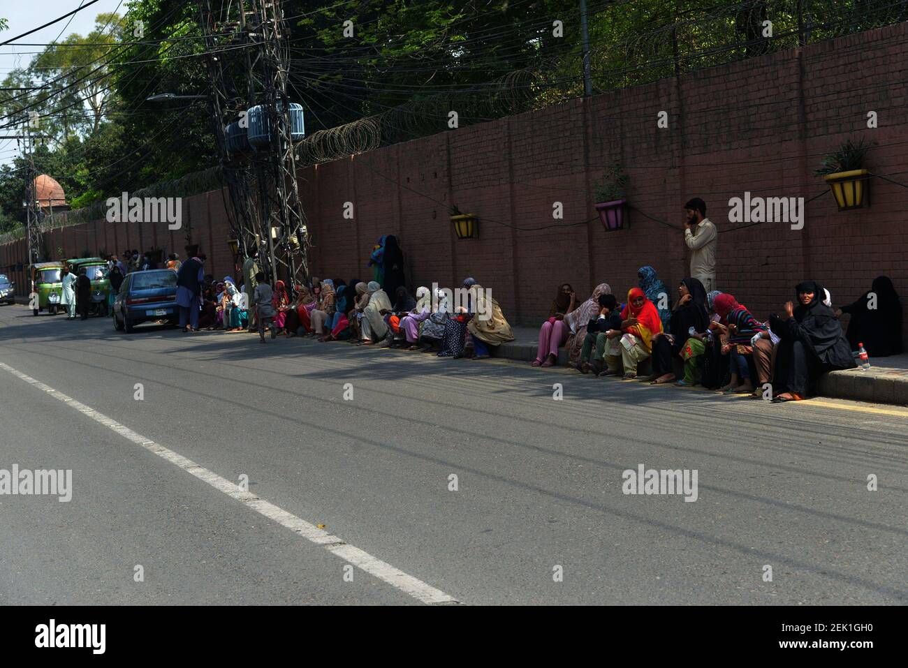 A large numbers of deserving poor women sitting on Davis Road side as ...