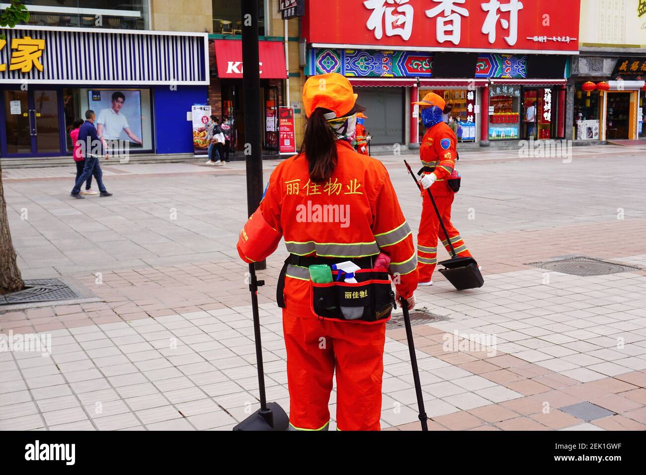 Sanitation workers on the Wangfujing Walkway clean the street by using ...
