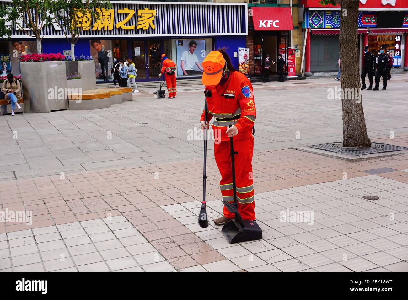 Sanitation workers on the Wangfujing Walkway clean the street by using ...