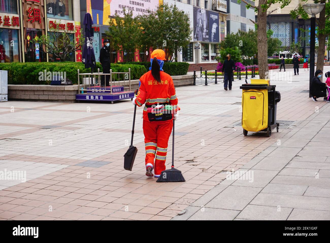 Sanitation workers on the Wangfujing Walkway clean the street by using ...