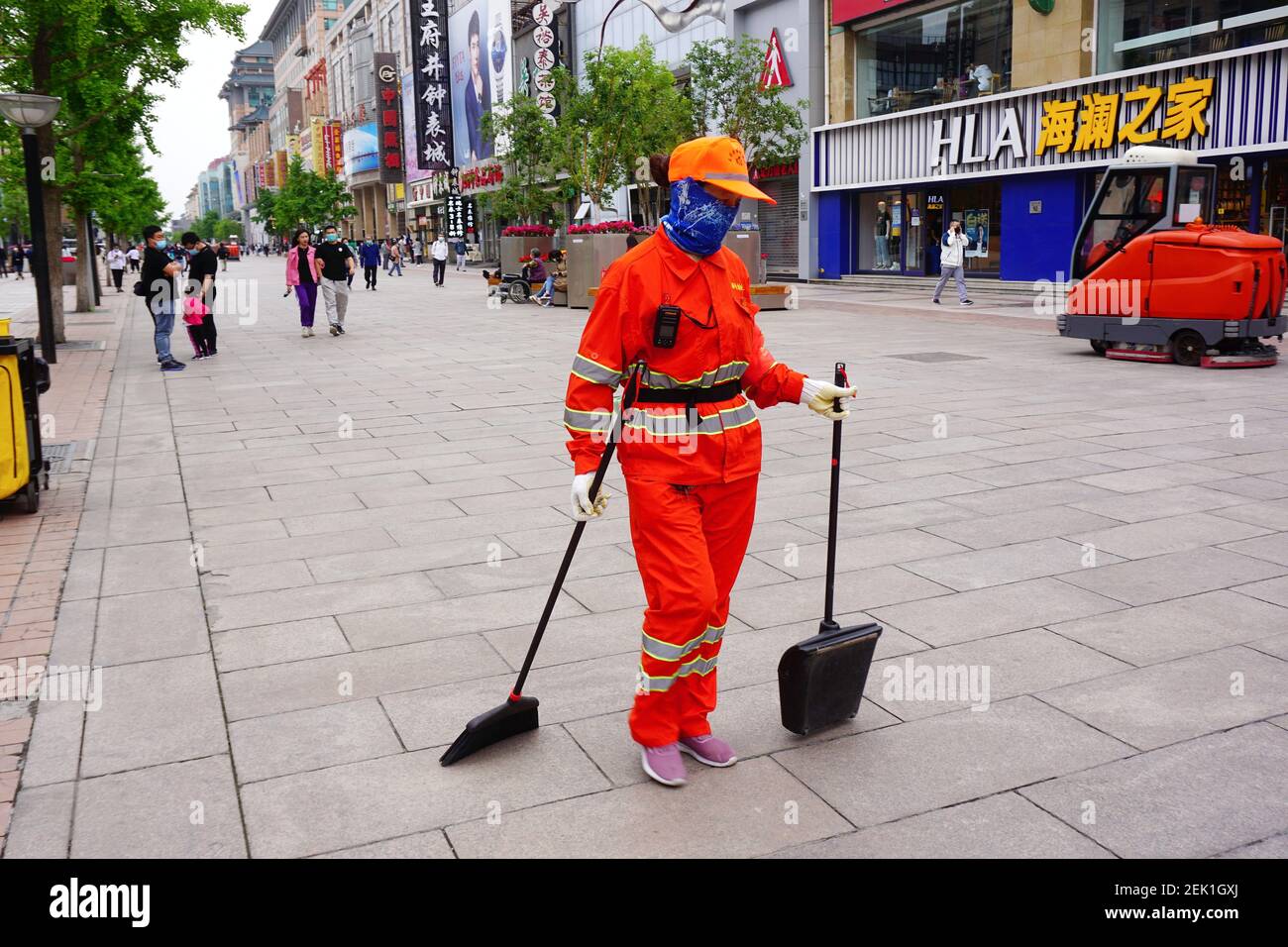 Sanitation workers on the Wangfujing Walkway clean the street by using ...