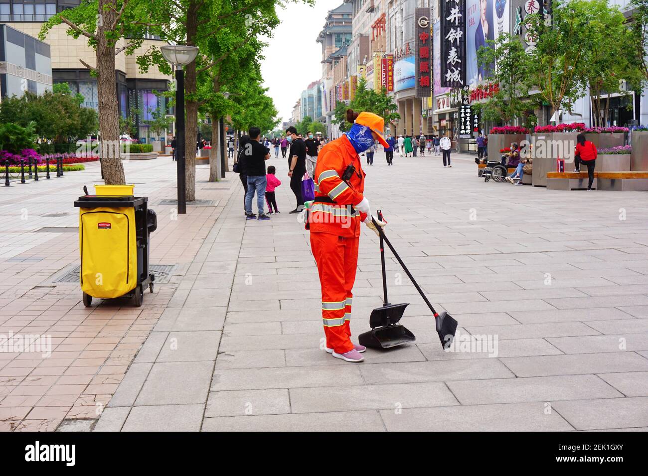 Sanitation workers on the Wangfujing Walkway clean the street by using ...