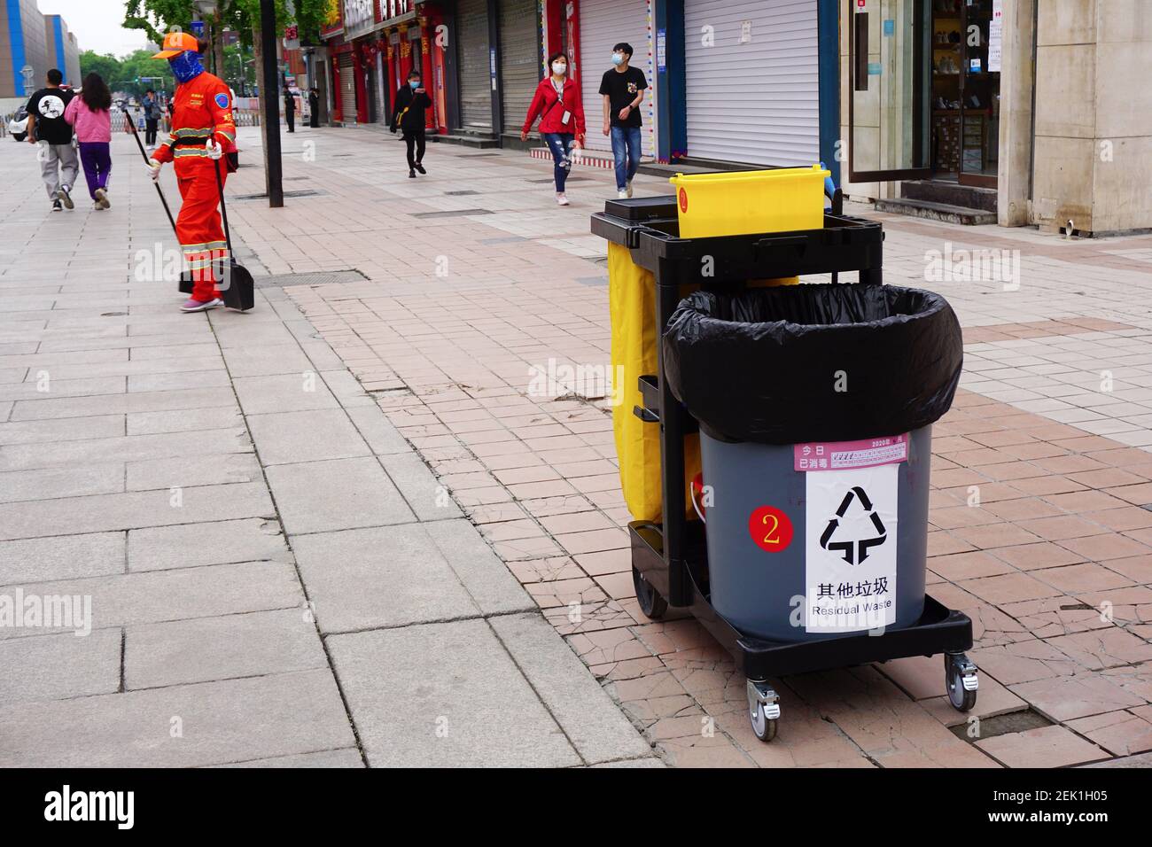 Sanitation workers on the Wangfujing Walkway clean the street by using ...