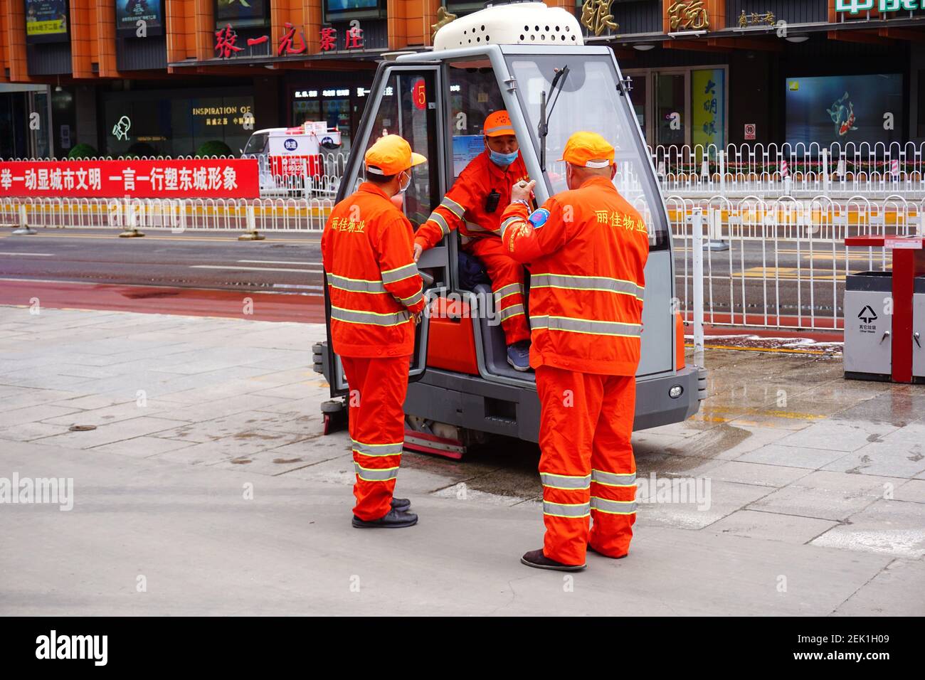 Sanitation workers on the Wangfujing Walkway clean the street by using ...