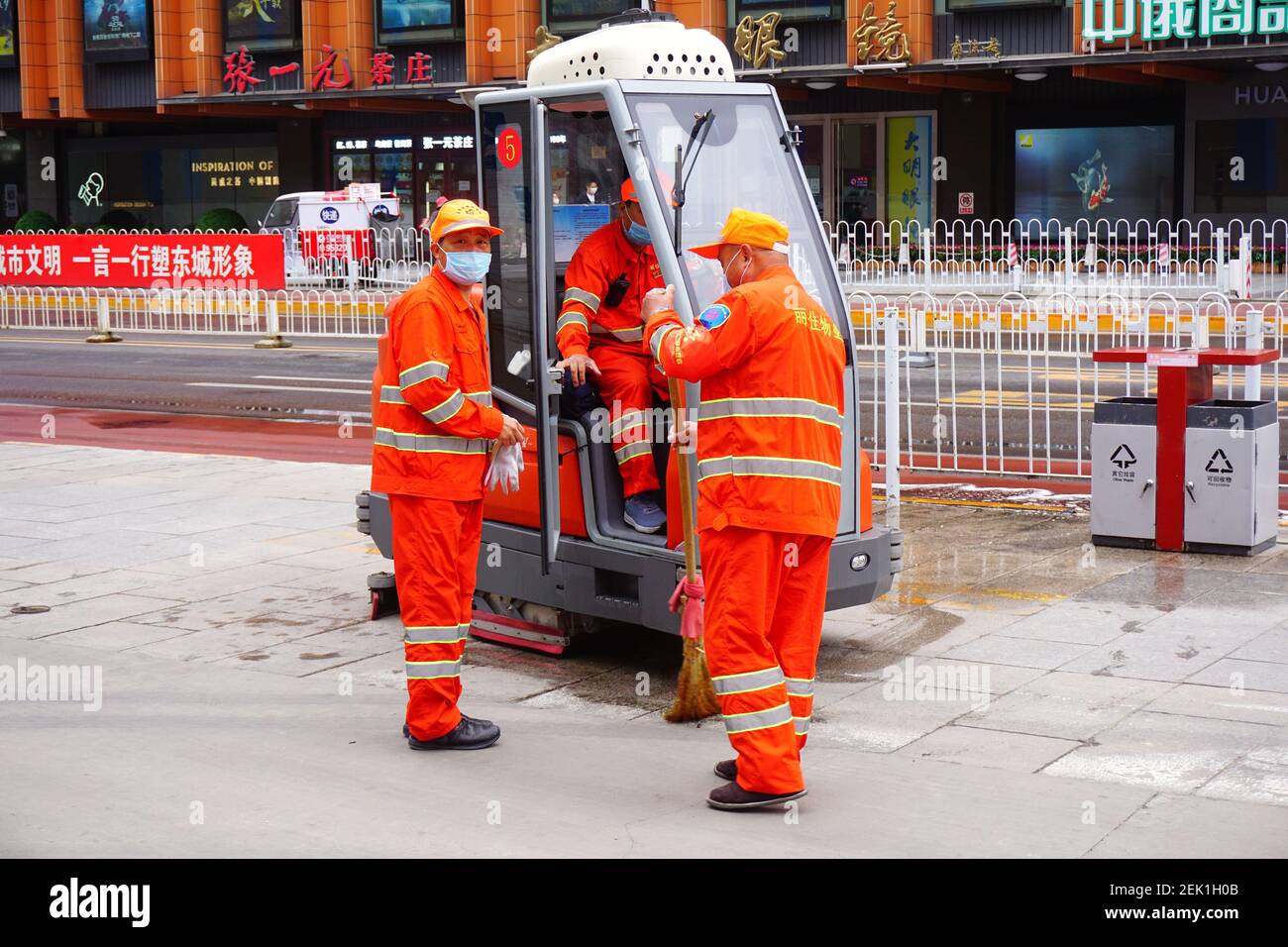 Sanitation workers on the Wangfujing Walkway clean the street by using ...