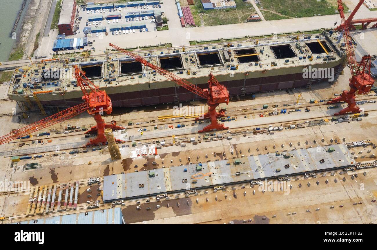 An aerial view of ships under construction at the pier of a local ...
