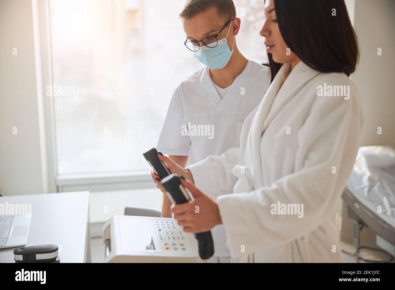 Doctor monitoring his patient health with a body composition analyzer ...