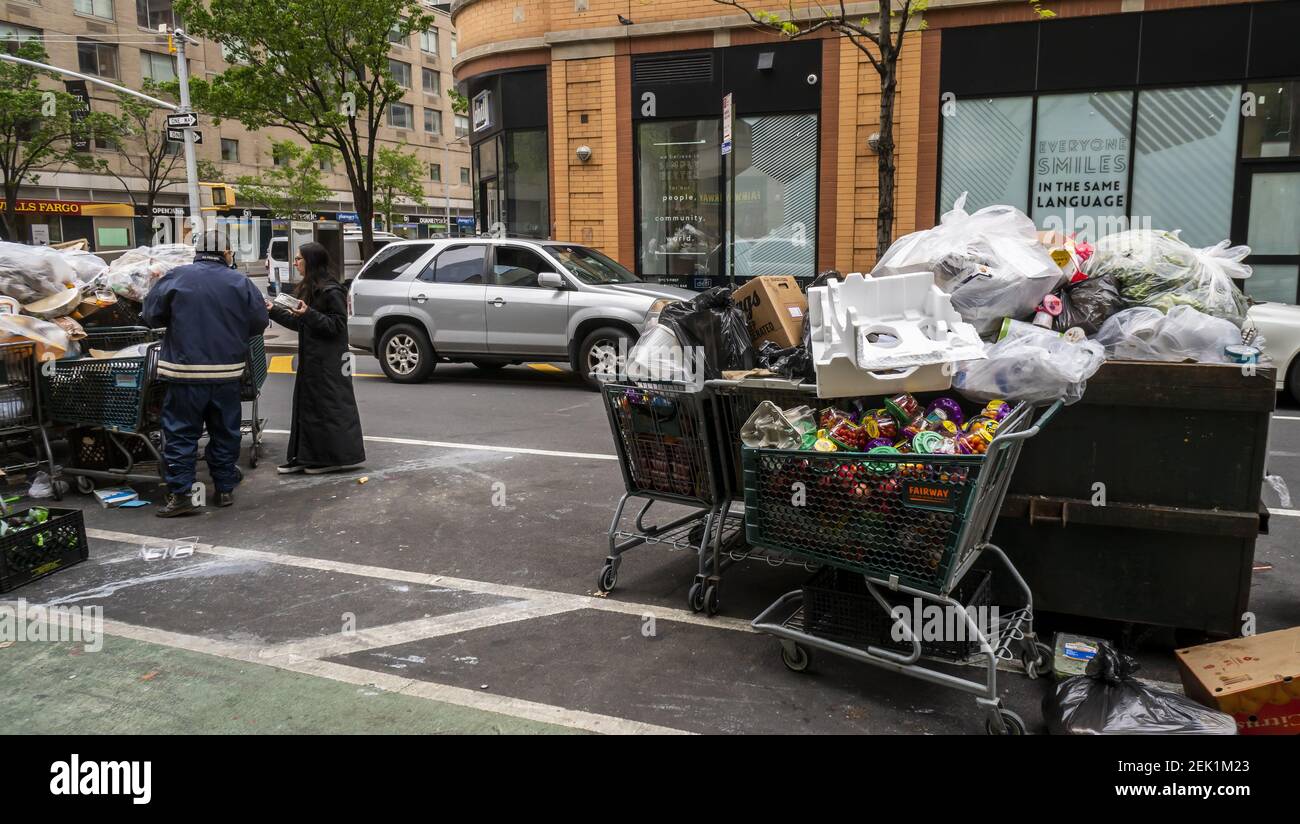 People browse through the garbage outside of a Fairway supermarket in ...