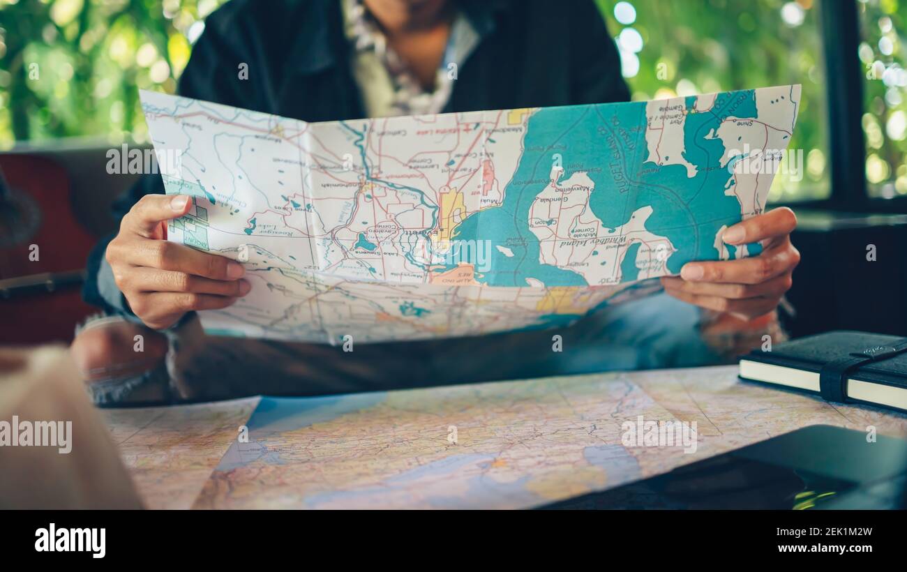 Tourist hold map and planning and reservation. Travel, holiday ...
