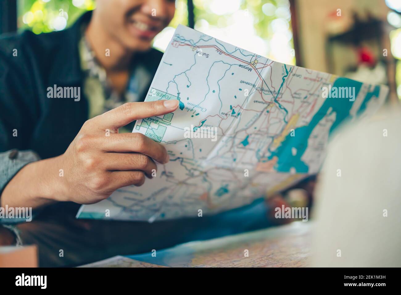 Tourist hold map and planning and reservation. Travel, holiday ...