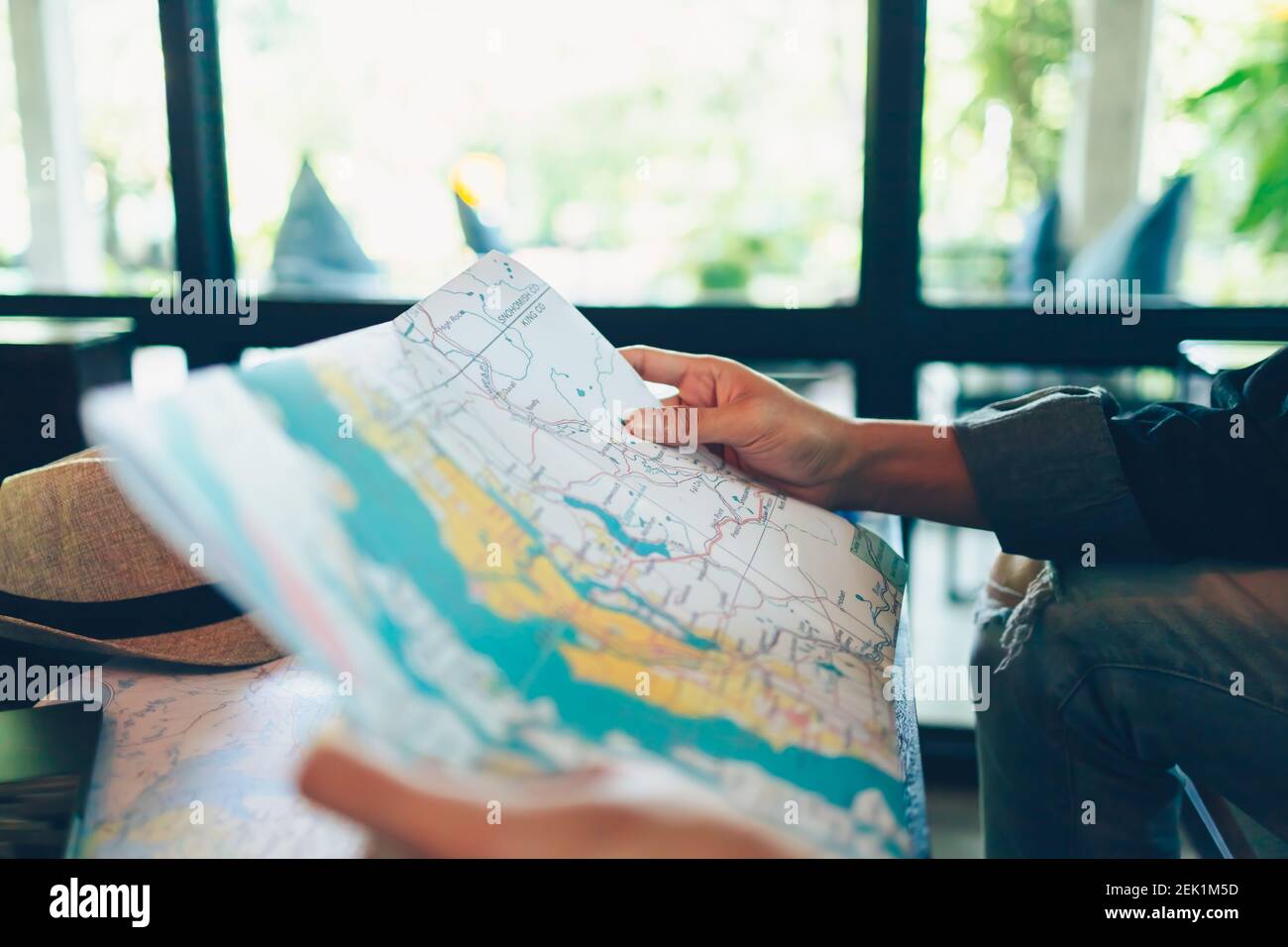 Tourist hold map and planning and reservation. Travel, holiday ...