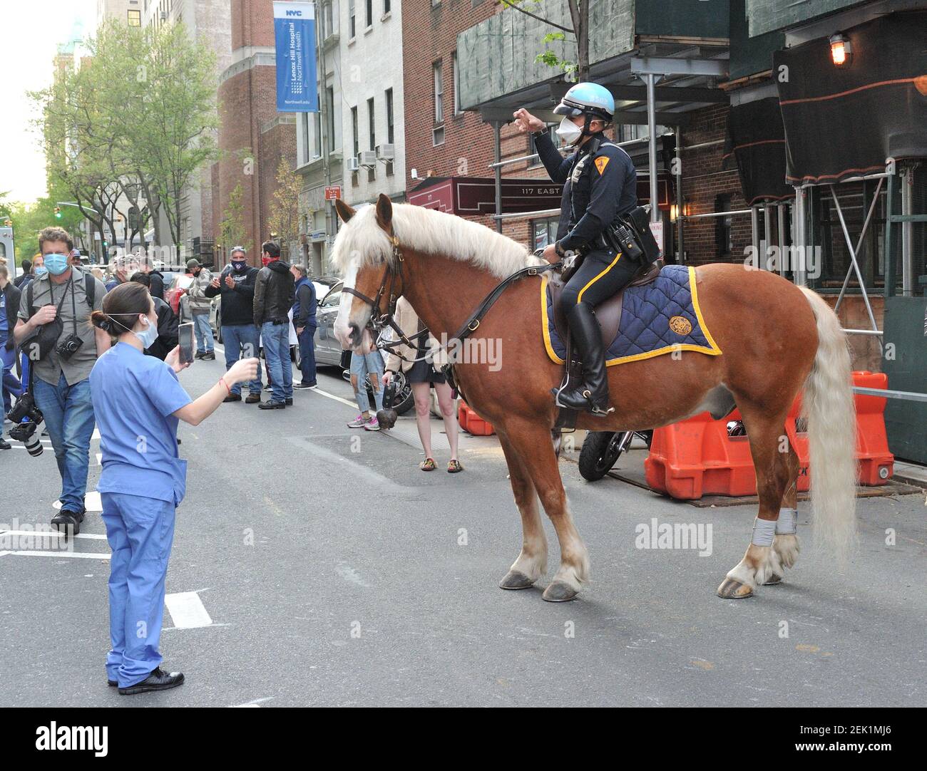 NYPD mounted patrol officer with hospital staff outside Lenox Hill ...