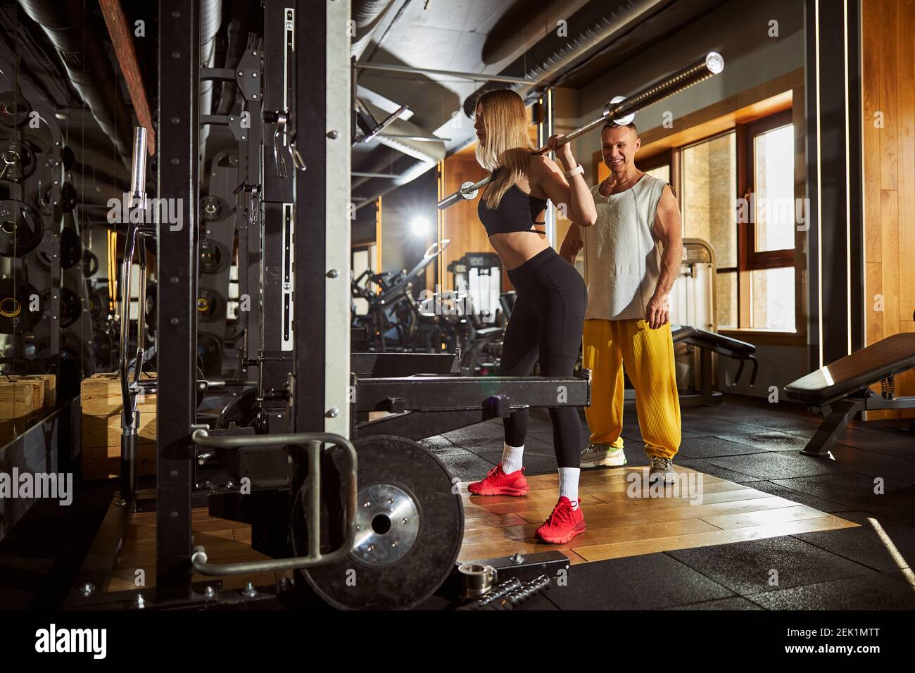 Concentrated lady doing a set of weight-lifting exercises Stock Photo ...