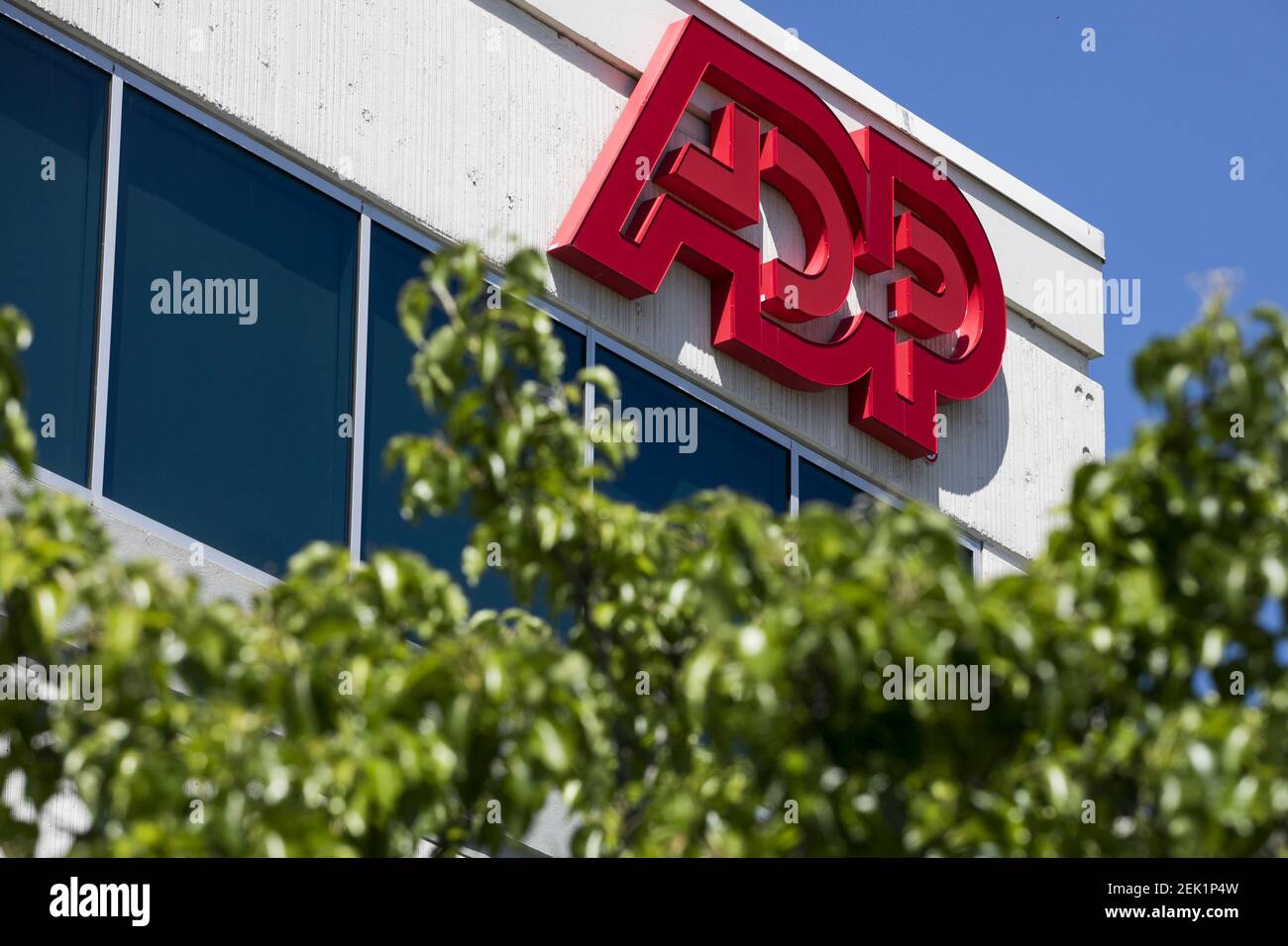 A logo sign outside of a facility occupied by Automatic Data Processing ...