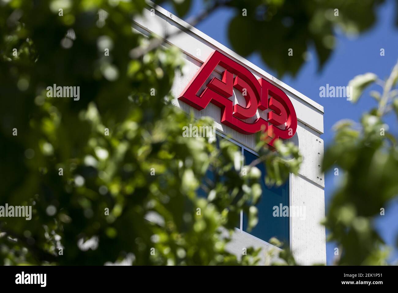 A logo sign outside of a facility occupied by Automatic Data Processing ...