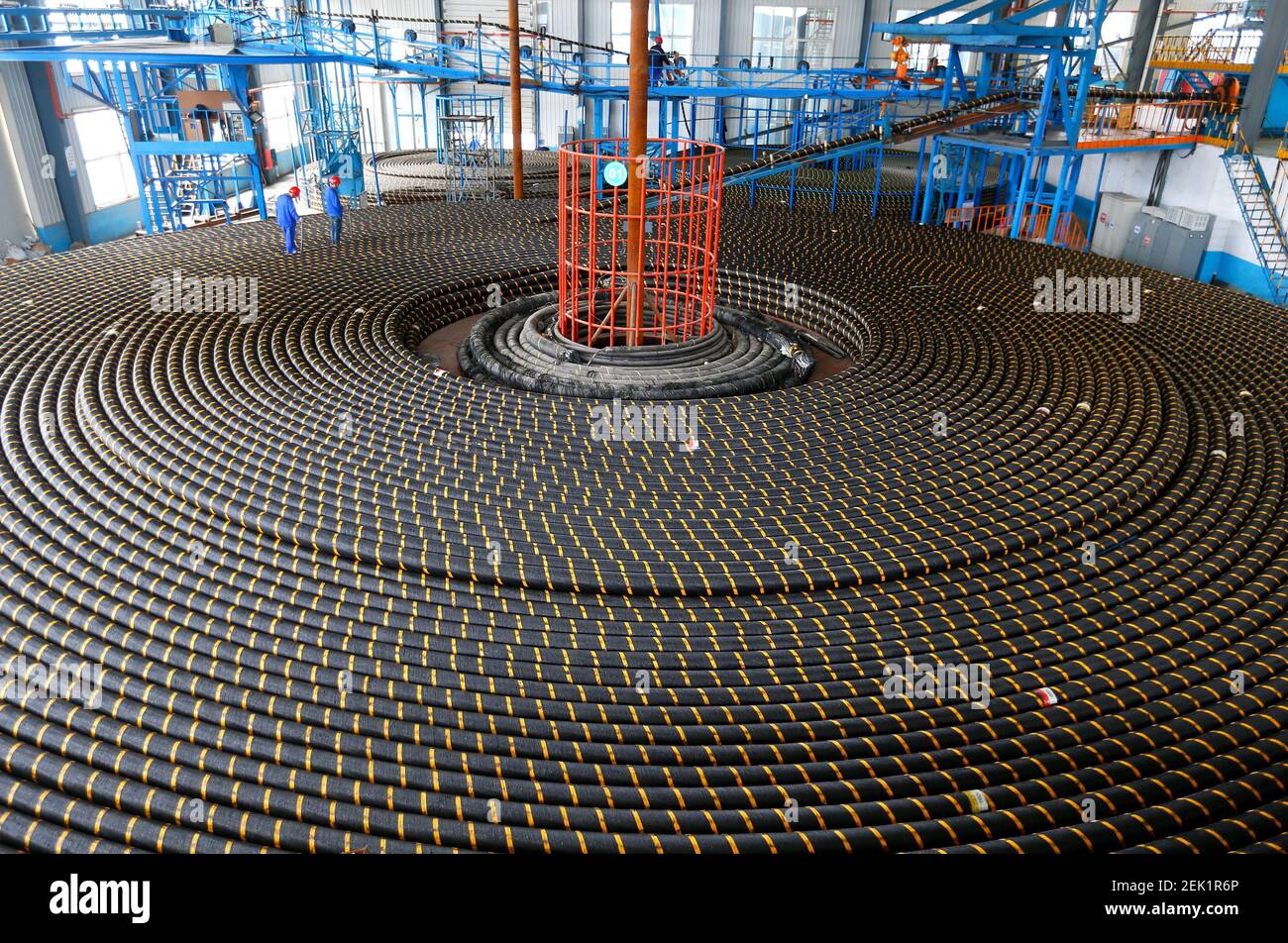 With the help of machines, workers produce submarine communication ...