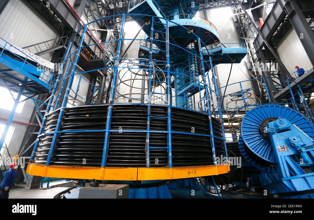 With the help of machines, workers produce submarine communication ...