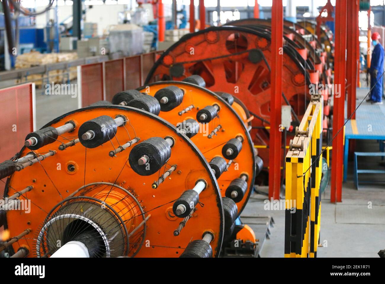With the help of machines, workers produce submarine communication ...