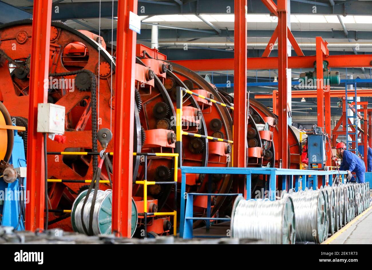 With the help of machines, workers produce submarine communication ...