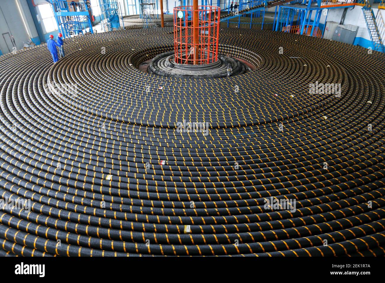 With the help of machines, workers produce submarine communication ...