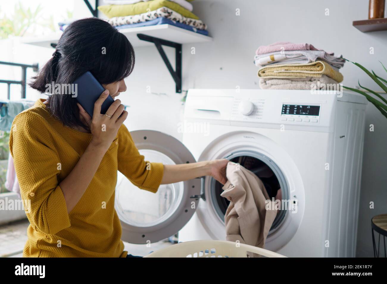 Woman laundry basket talking on hi-res stock photography and images - Alamy
