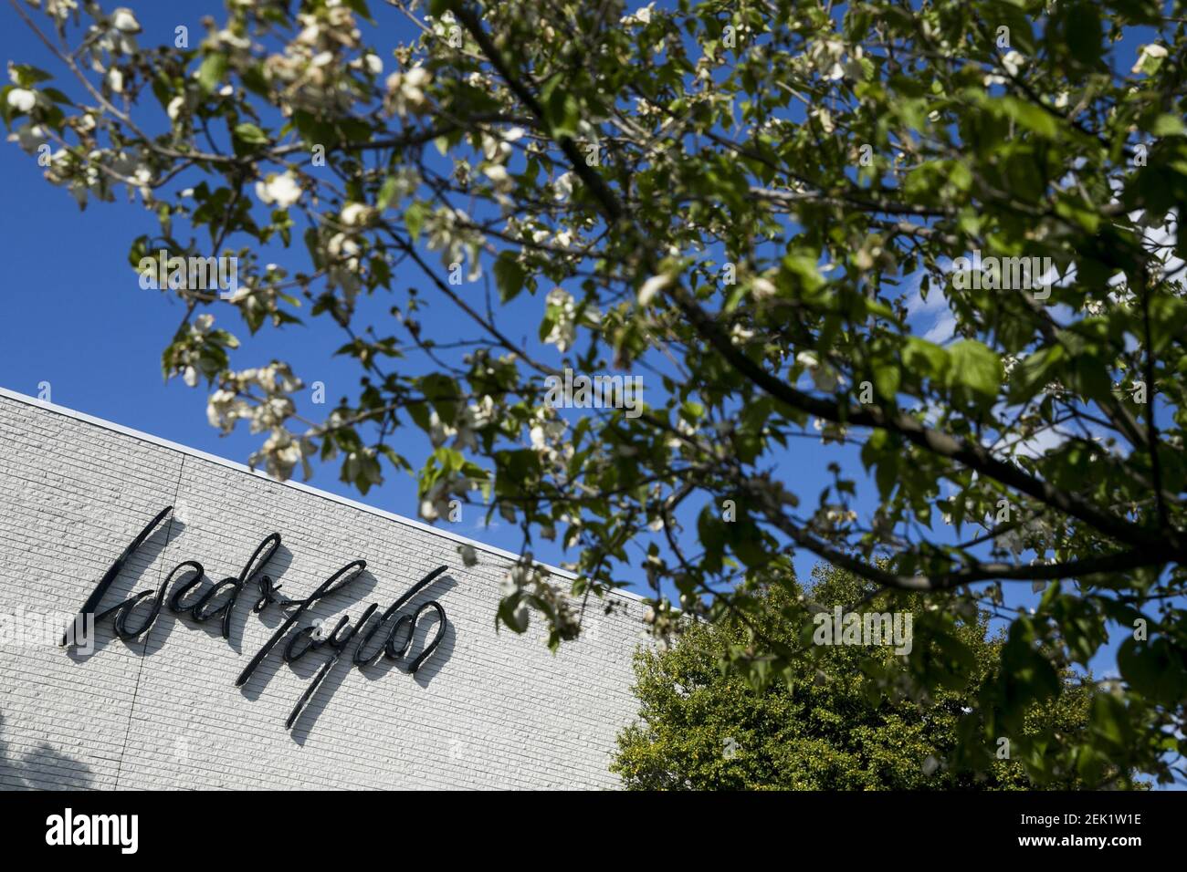 A logo sign outside of a Lord & Taylor department store location in ...