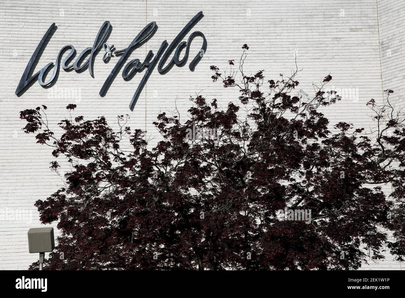 A logo sign outside of a Lord & Taylor department store location in ...