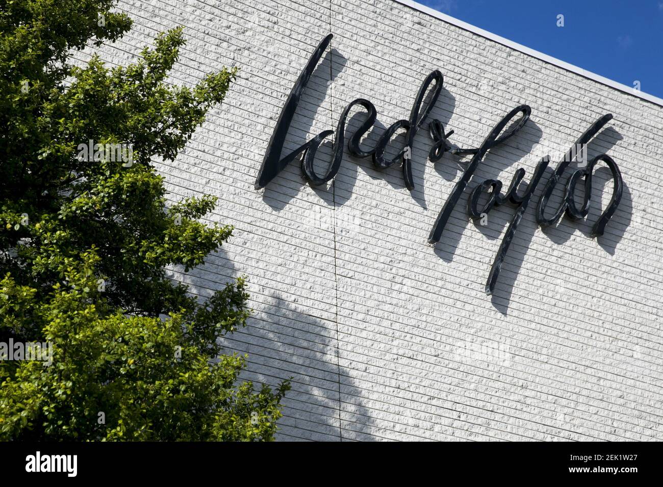 A logo sign outside of a Lord & Taylor department store location in ...