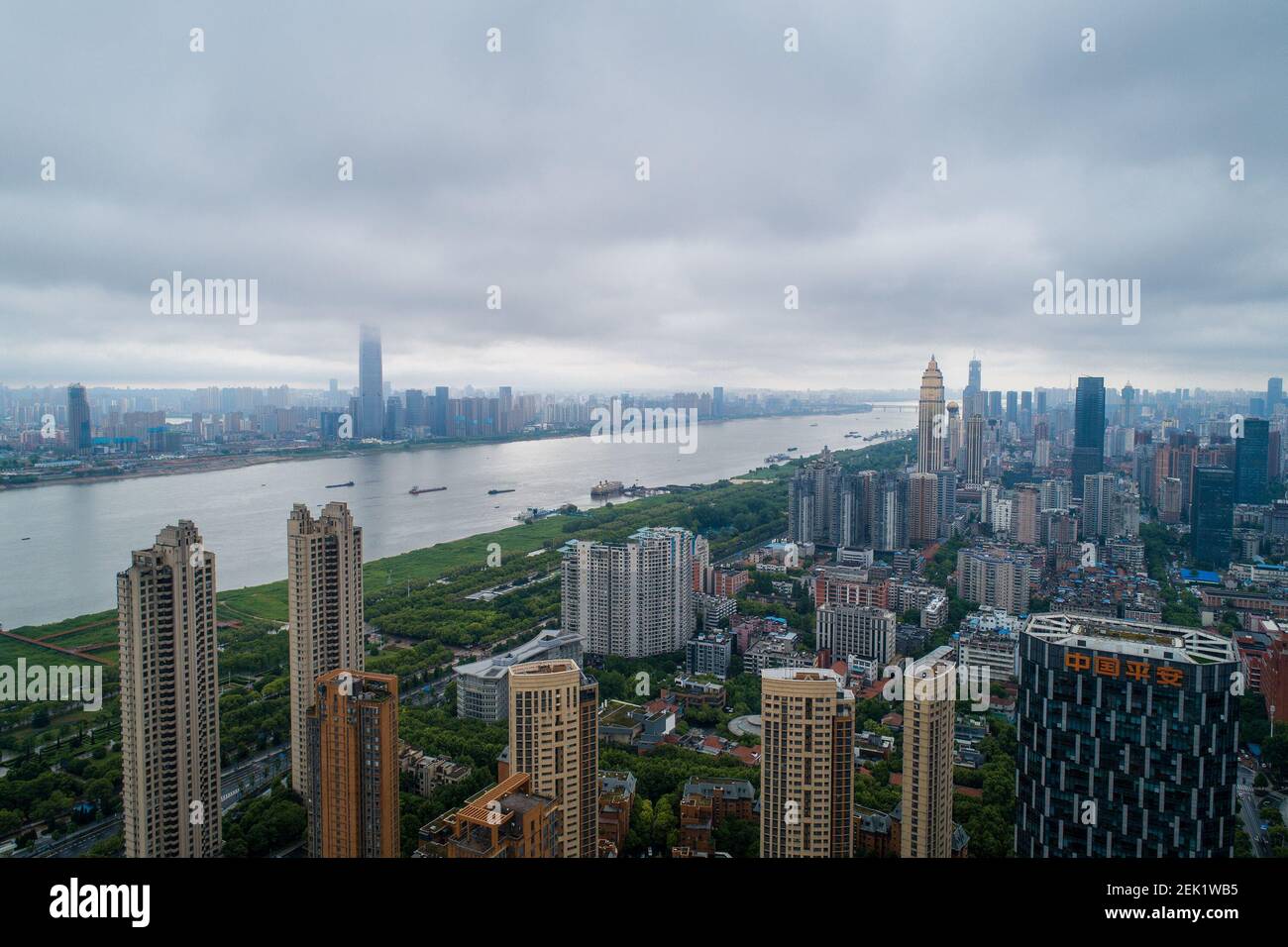 An aerial view of skyscrapers standing in the city center along a river ...