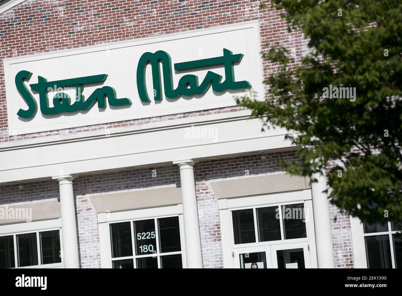 A logo sign outside of a Stein Mart retail store location in ...