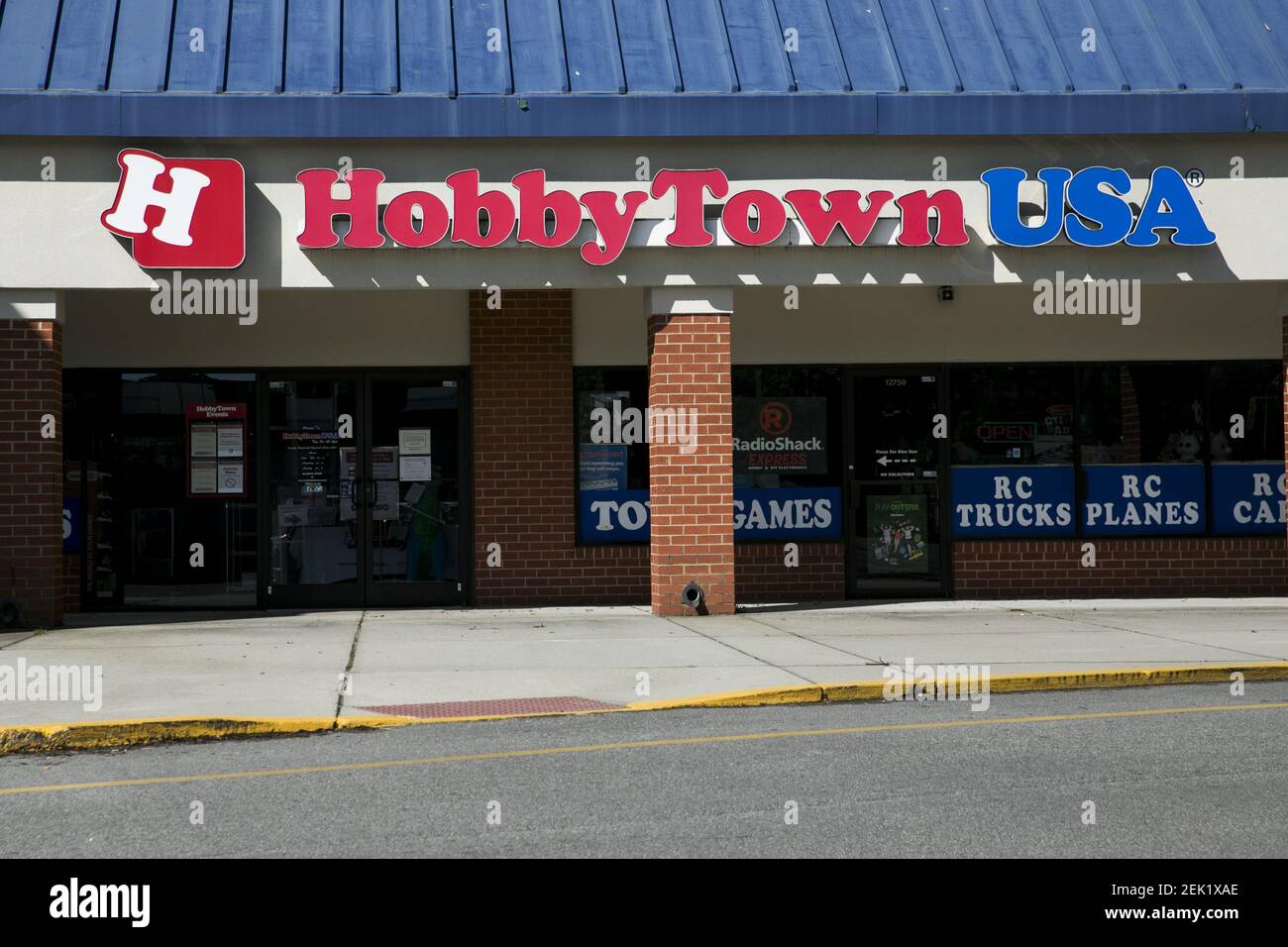 A logo sign outside of a HobbyTown USA retail store location in Newport ...
