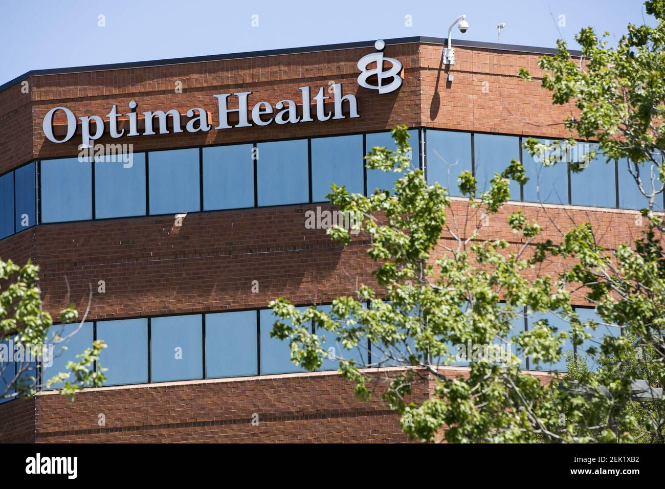 A logo sign outside of the headquarters of Optima Health in Virginia ...