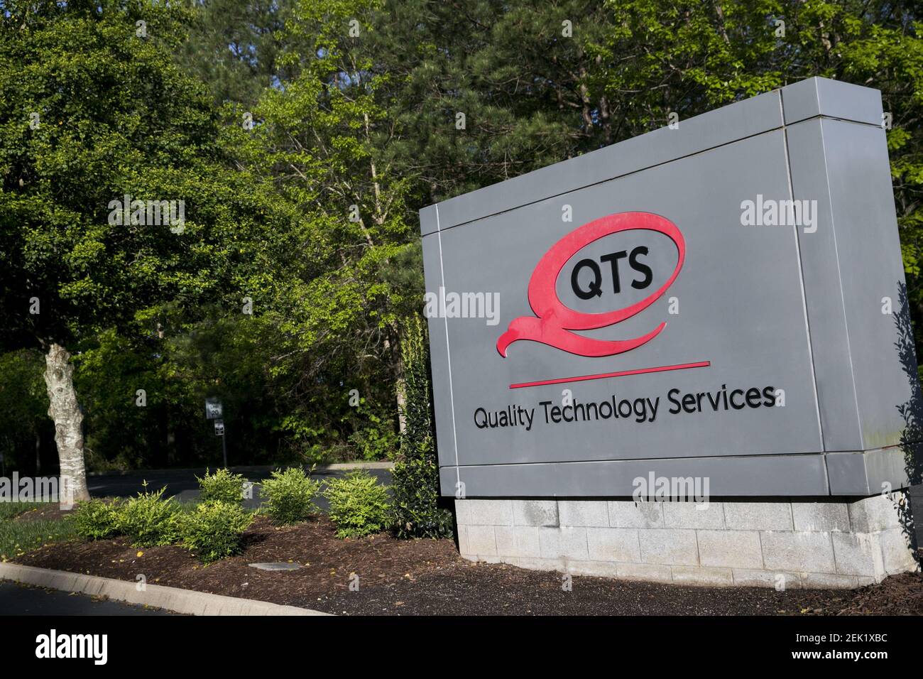 A logo sign outside of a Quality Technology Services (QTS) Data Center ...