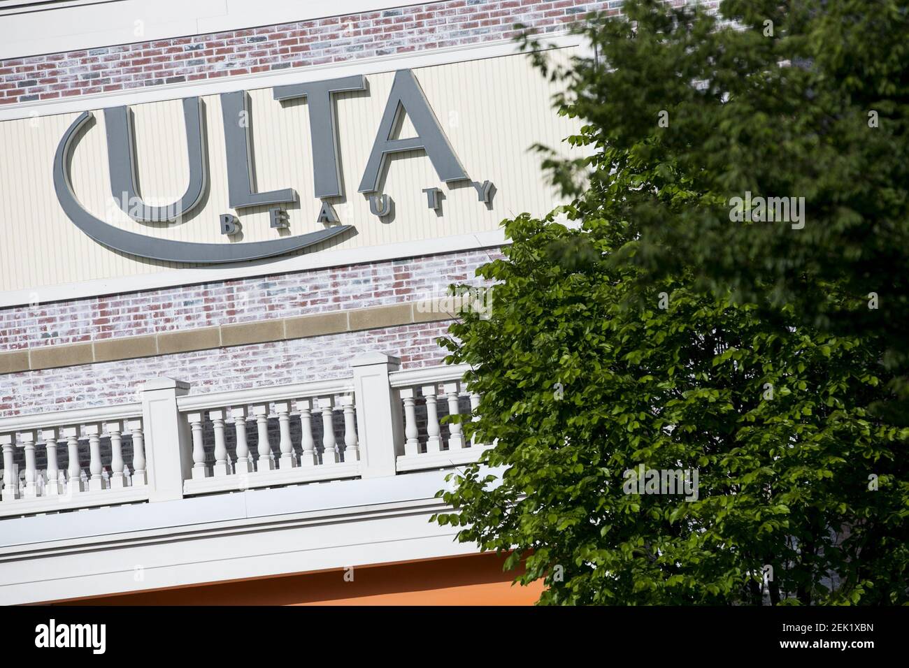 A logo sign outside of a Ulta Beauty retail store location in ...
