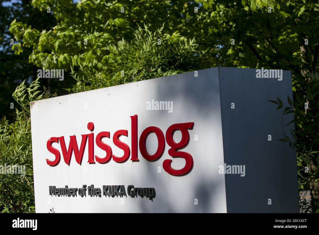 A logo sign outside of a facility occupied by Swisslog in Newport News ...