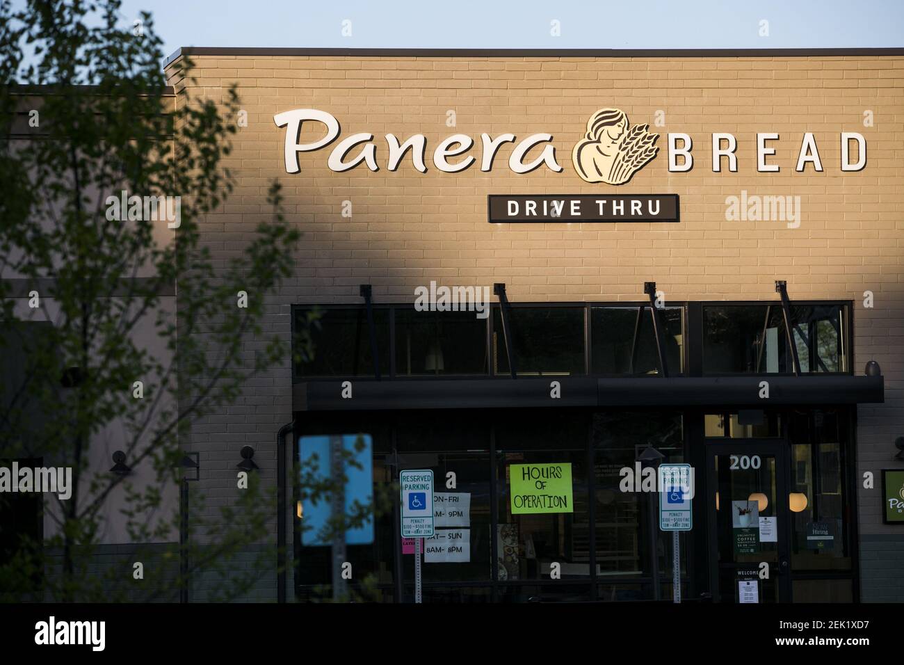 A logo sign outside of a Panera Bread restaurant location in Midlothian ...