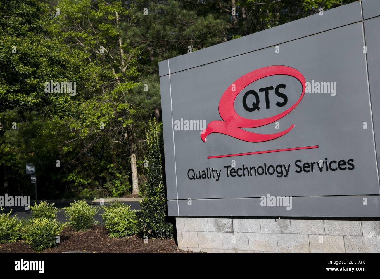 A logo sign outside of a Quality Technology Services (QTS) Data Center ...