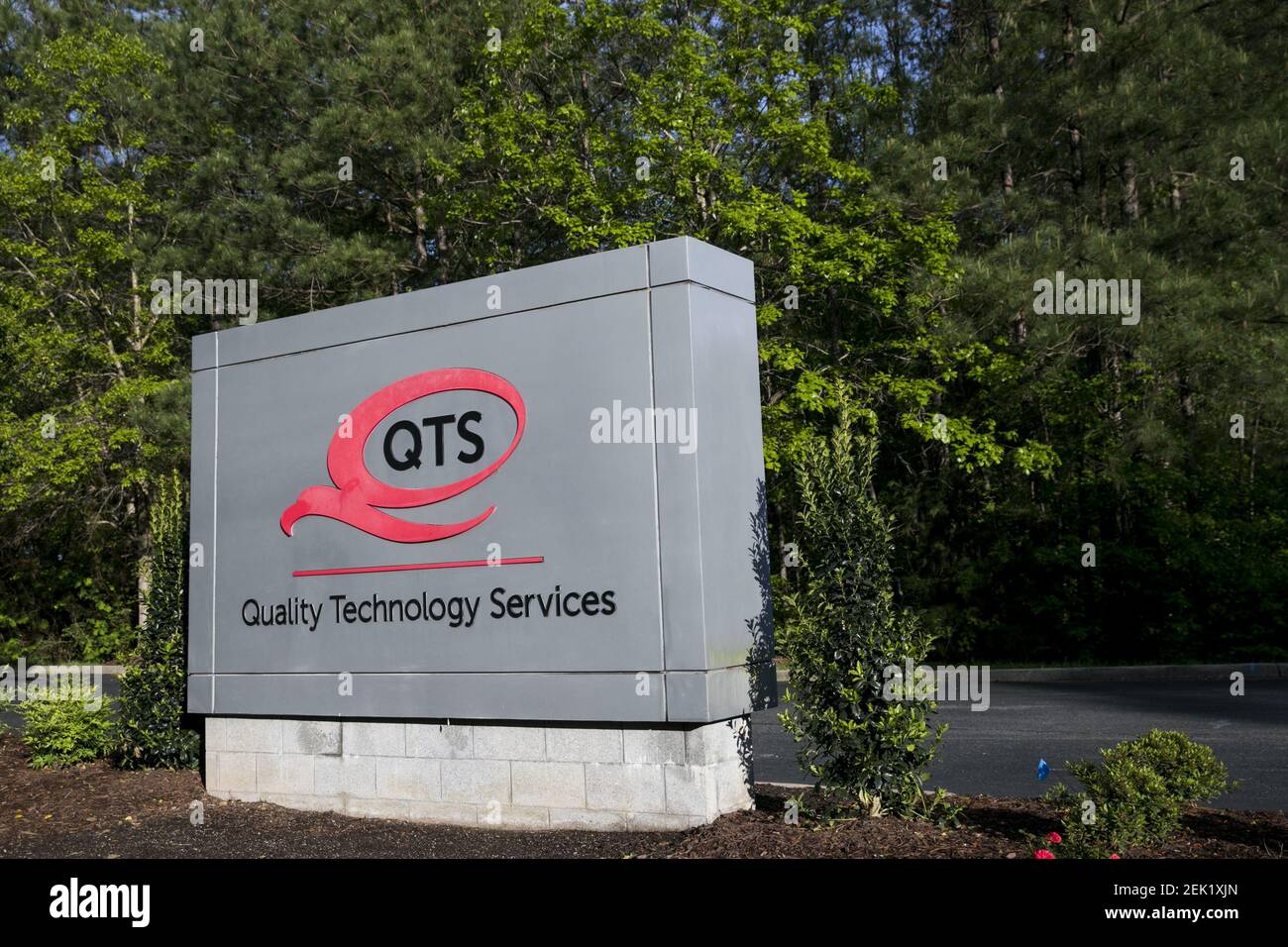 A logo sign outside of a Quality Technology Services (QTS) Data Center ...