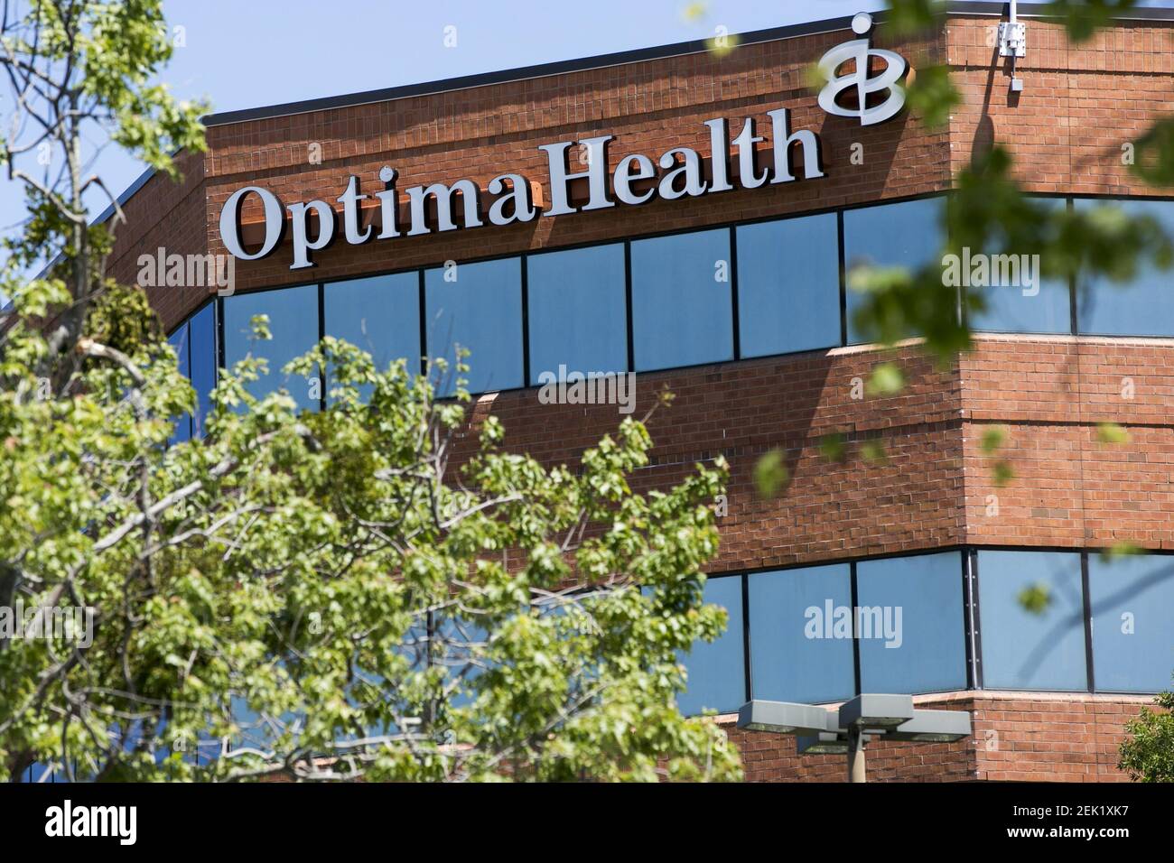 A logo sign outside of the headquarters of Optima Health in Virginia ...