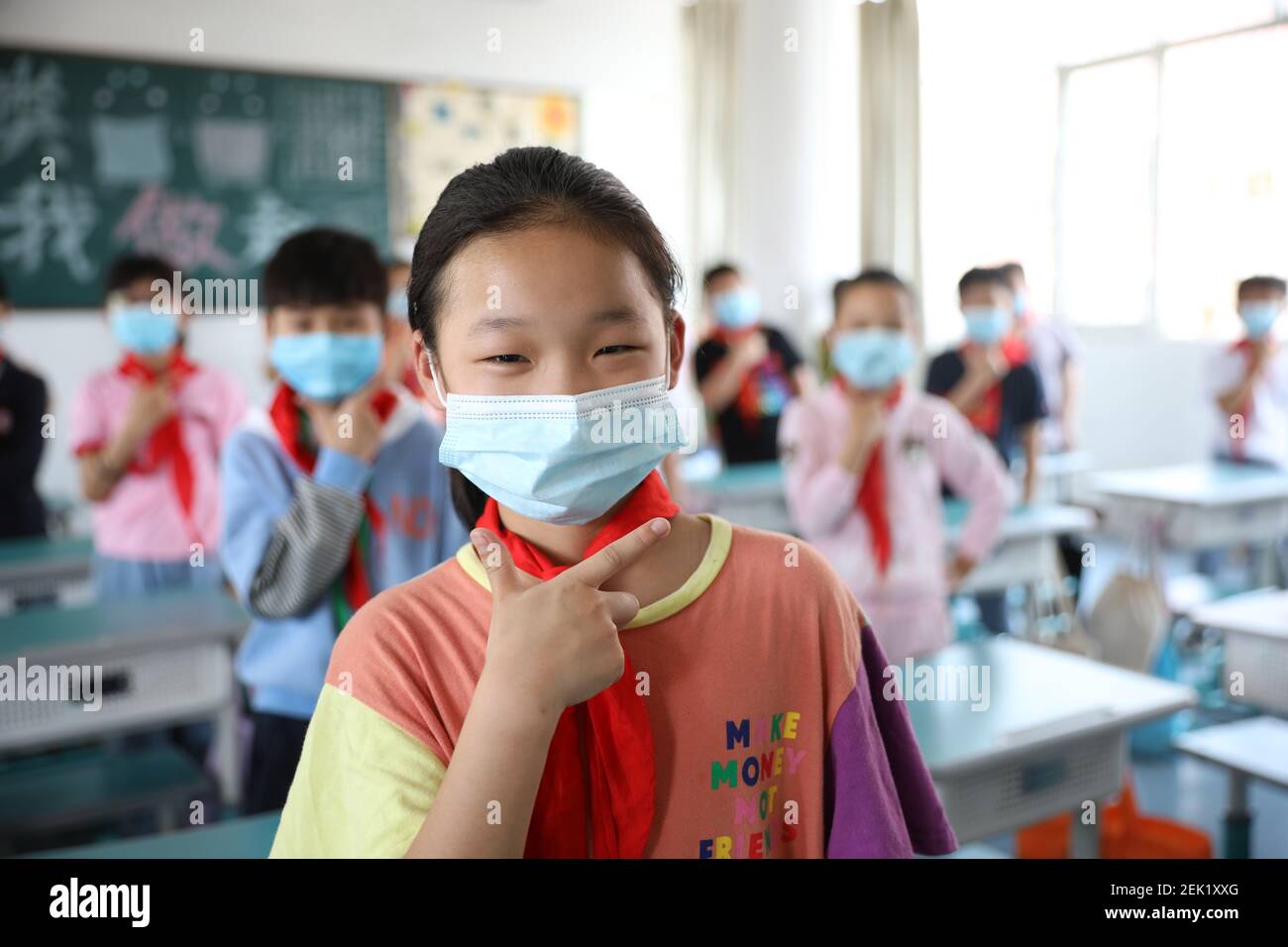 Local primary school students smile at the campus to celebrate the ...