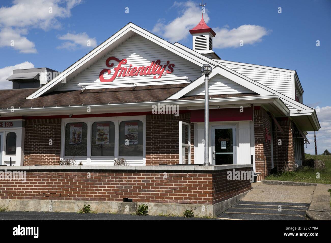 A logo sign outside of a Friendly's restaurant location in Hershey ...