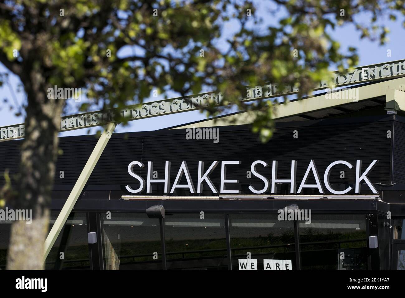 A logo sign outside of a Shake Shack restaurant location in King of ...