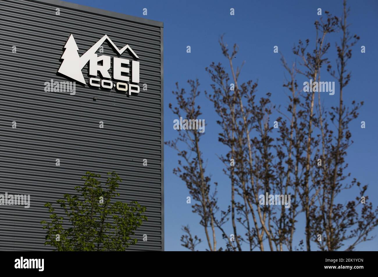 A logo sign outside of a Recreational Equipment, Inc., (REI) retail ...