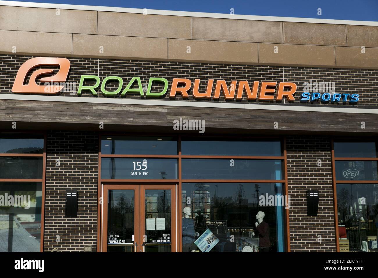 A logo sign outside of a Road Runner Sports retail store location in ...