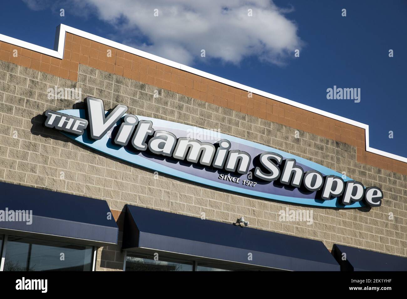 A logo sign outside of a The Vitamin Shoppe retail store location in ...