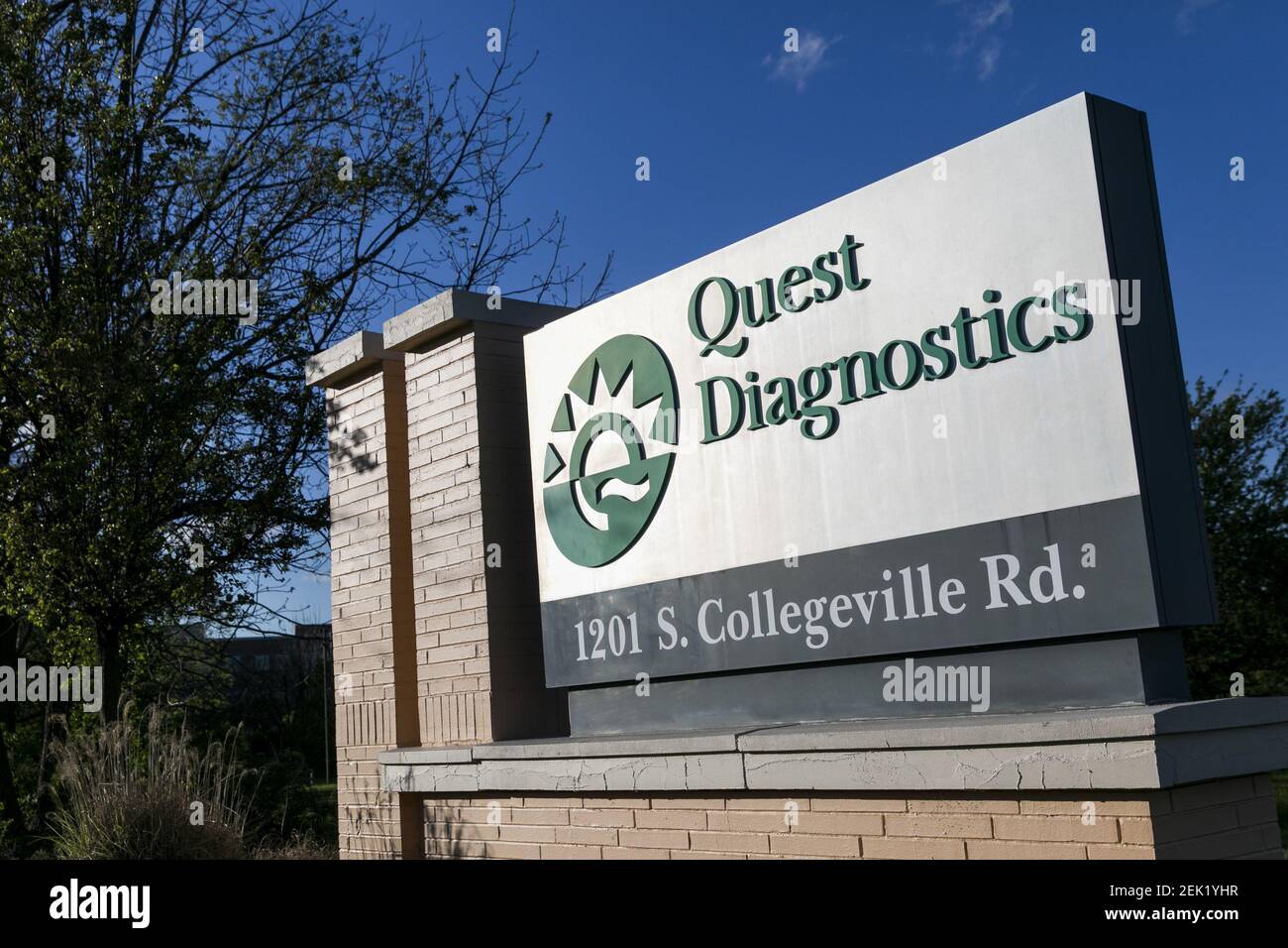 A logo sign outside of a facility occupied by Quest Diagnostics in ...