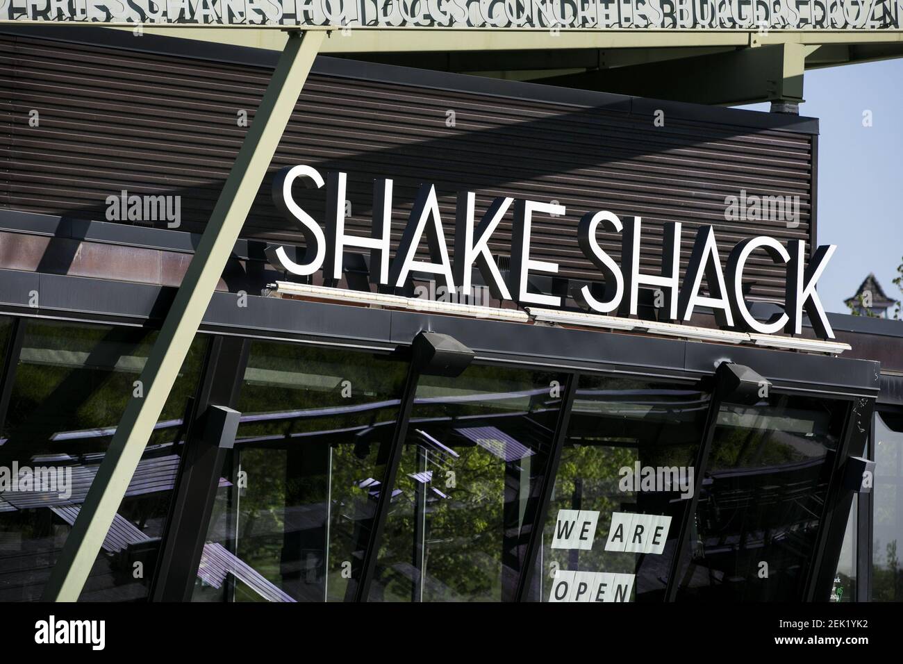 A logo sign outside of a Shake Shack restaurant location in King of ...
