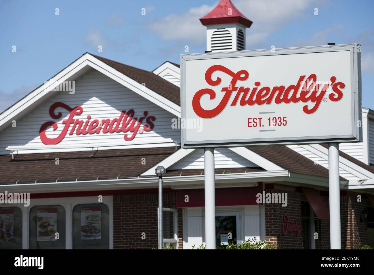 A logo sign outside of a Friendly's restaurant location in Hershey ...