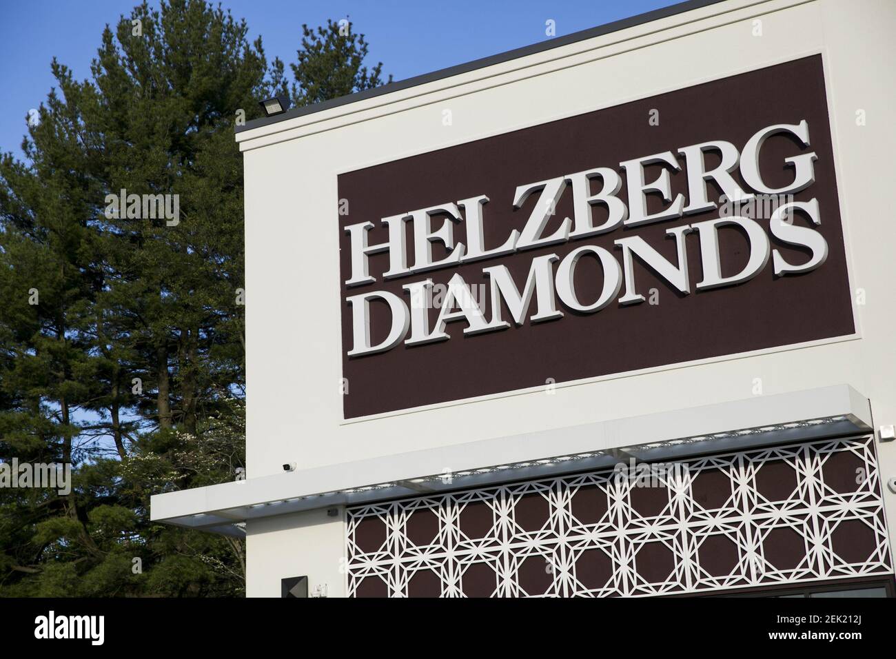 A logo sign outside of a Helzberg Diamonds retail store location in ...