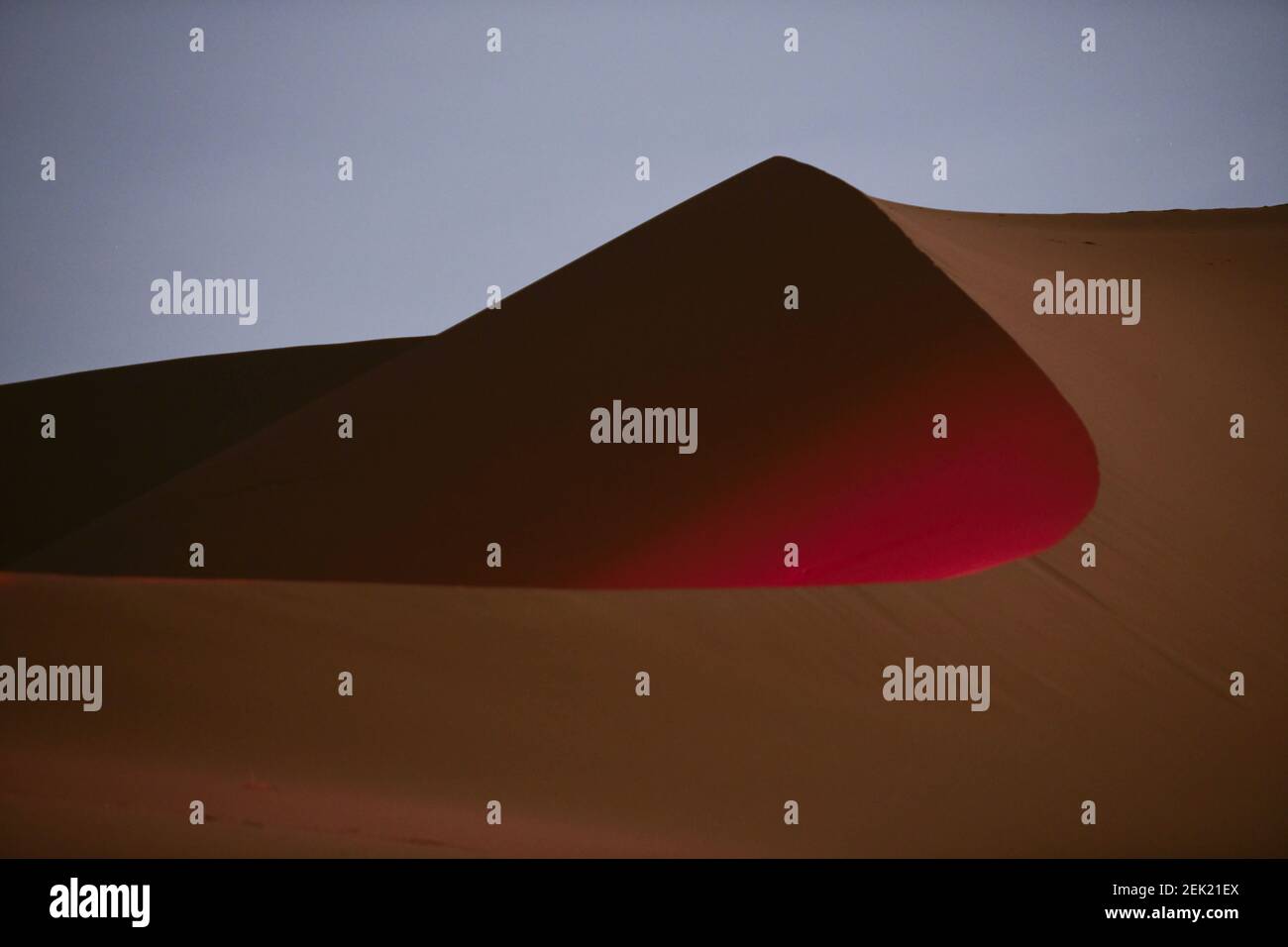 An aerial view of sunshine of the setting sun on the sand hills in the ...